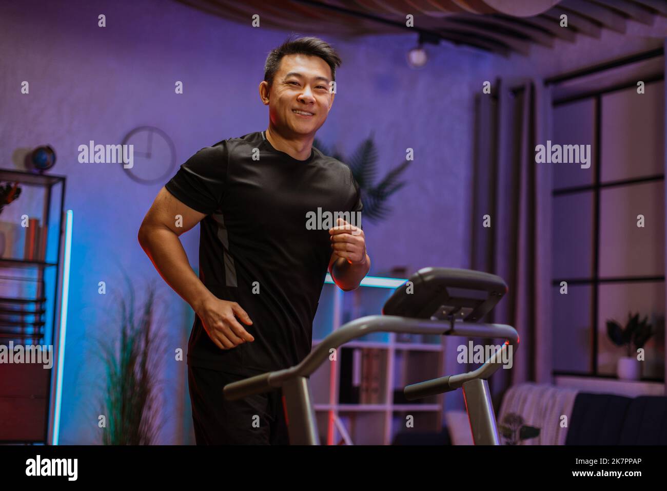 Handsome young asian man exercising, having workout on a treadmill in ...
