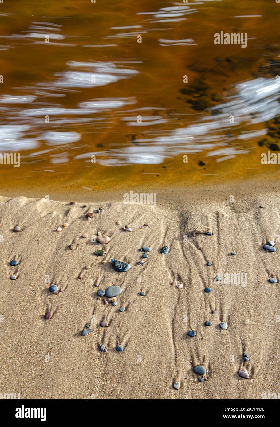 Bubbles from rapids in the waters of the Hurricane River swirl against ...