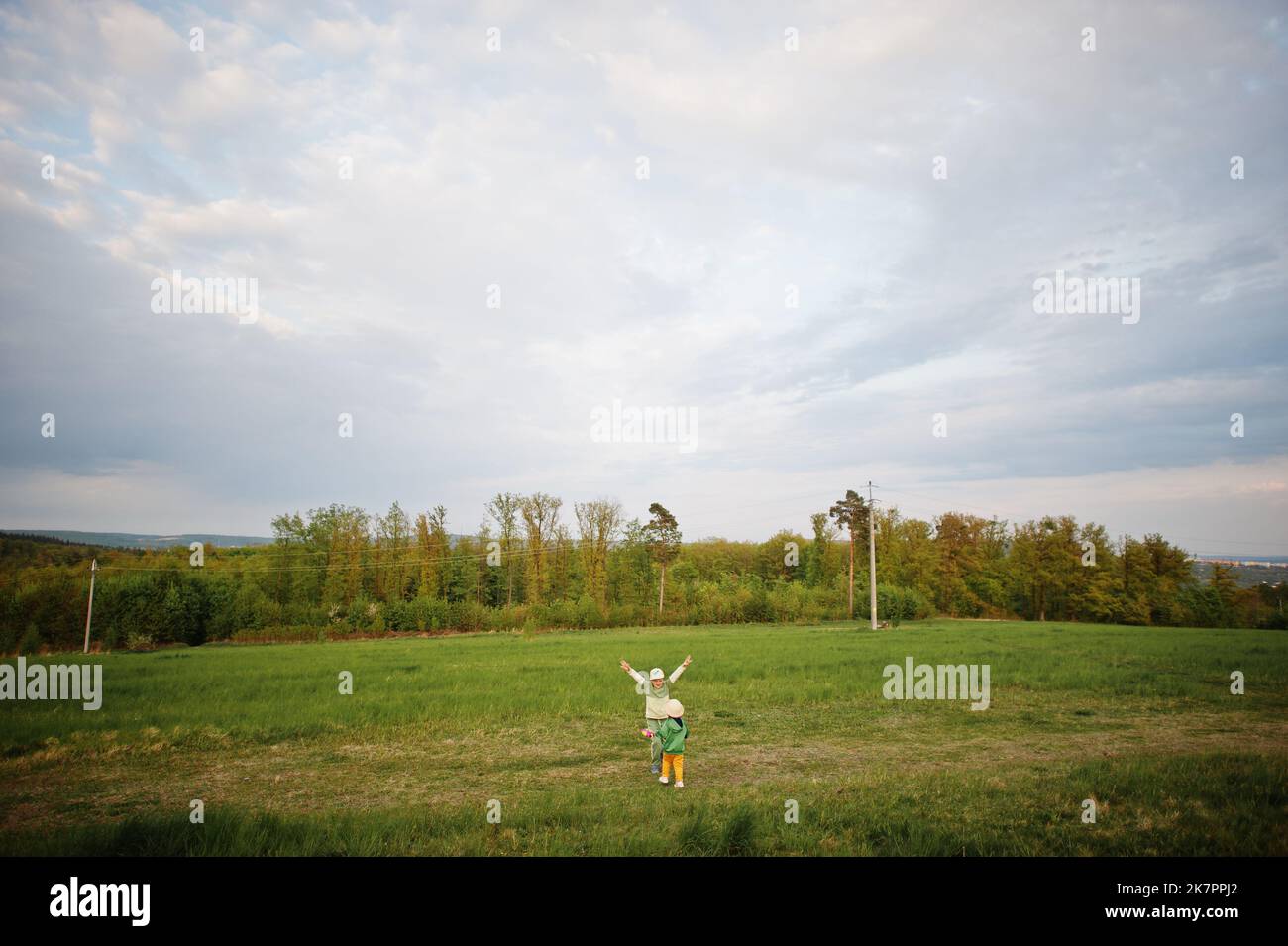 Brother with sister walking at meadow Stock Photo - Alamy