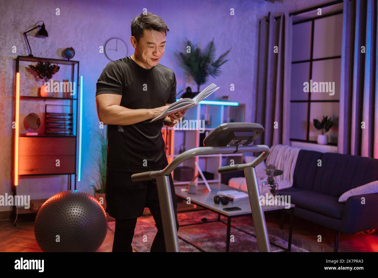 Portrait of handsome active and dynamic young asian man reading book ...