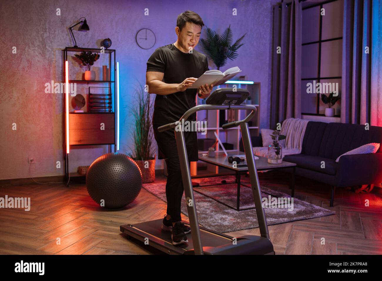 Attractive young sports asian man reading book working out, running ...