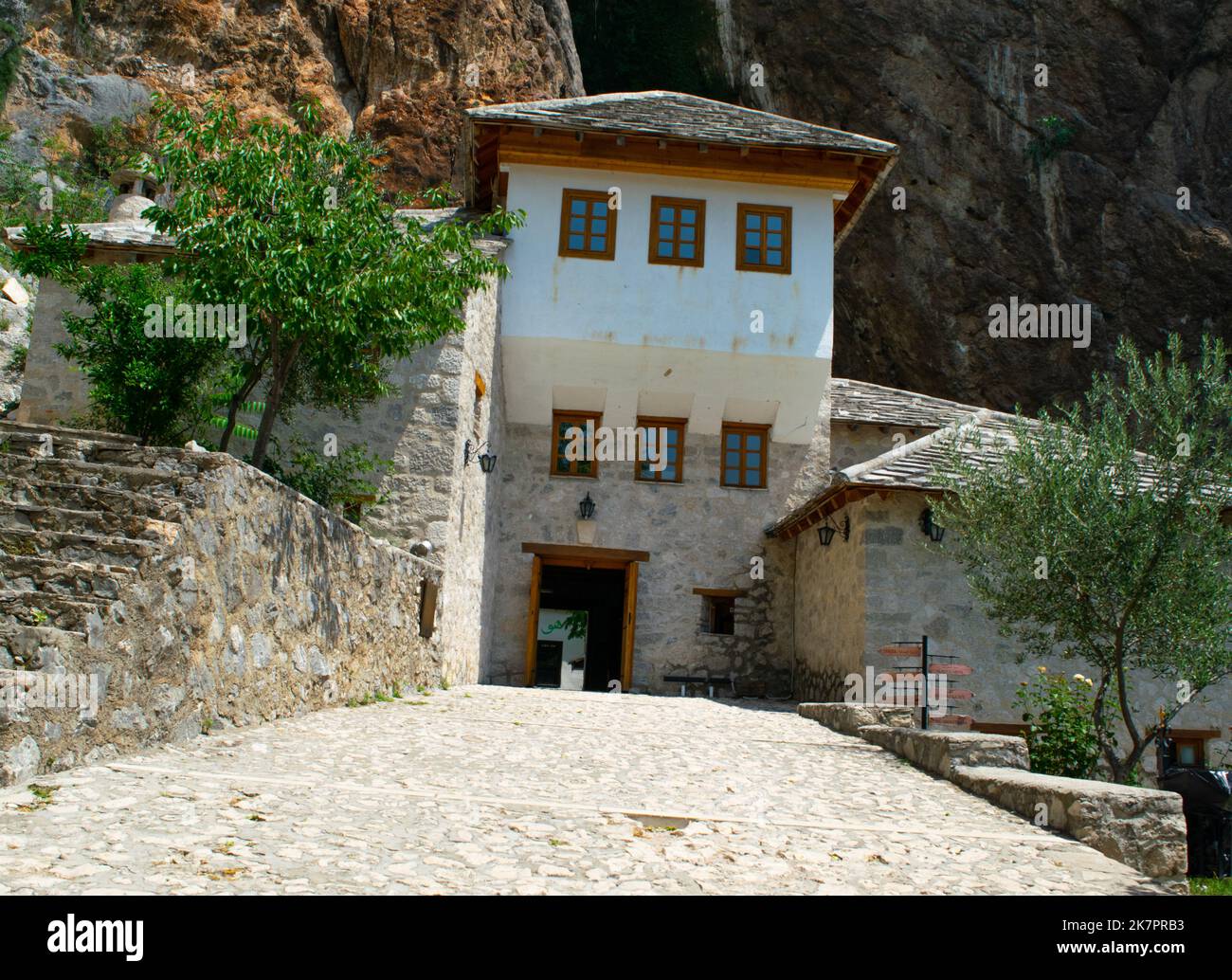Old religious house under a cliff Stock Photo - Alamy