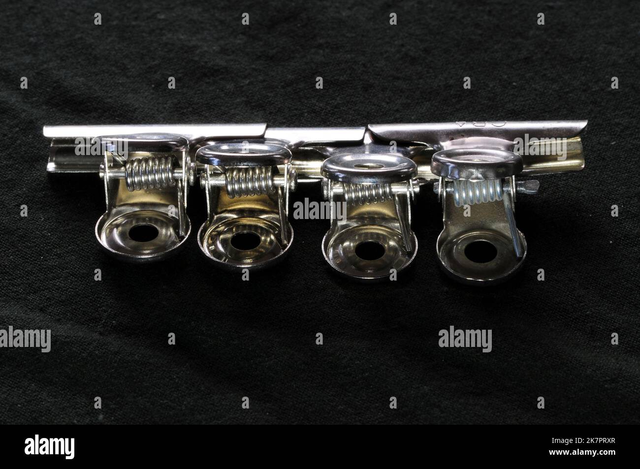 Four steel hinged bulldog paper clips Stock Photo - Alamy