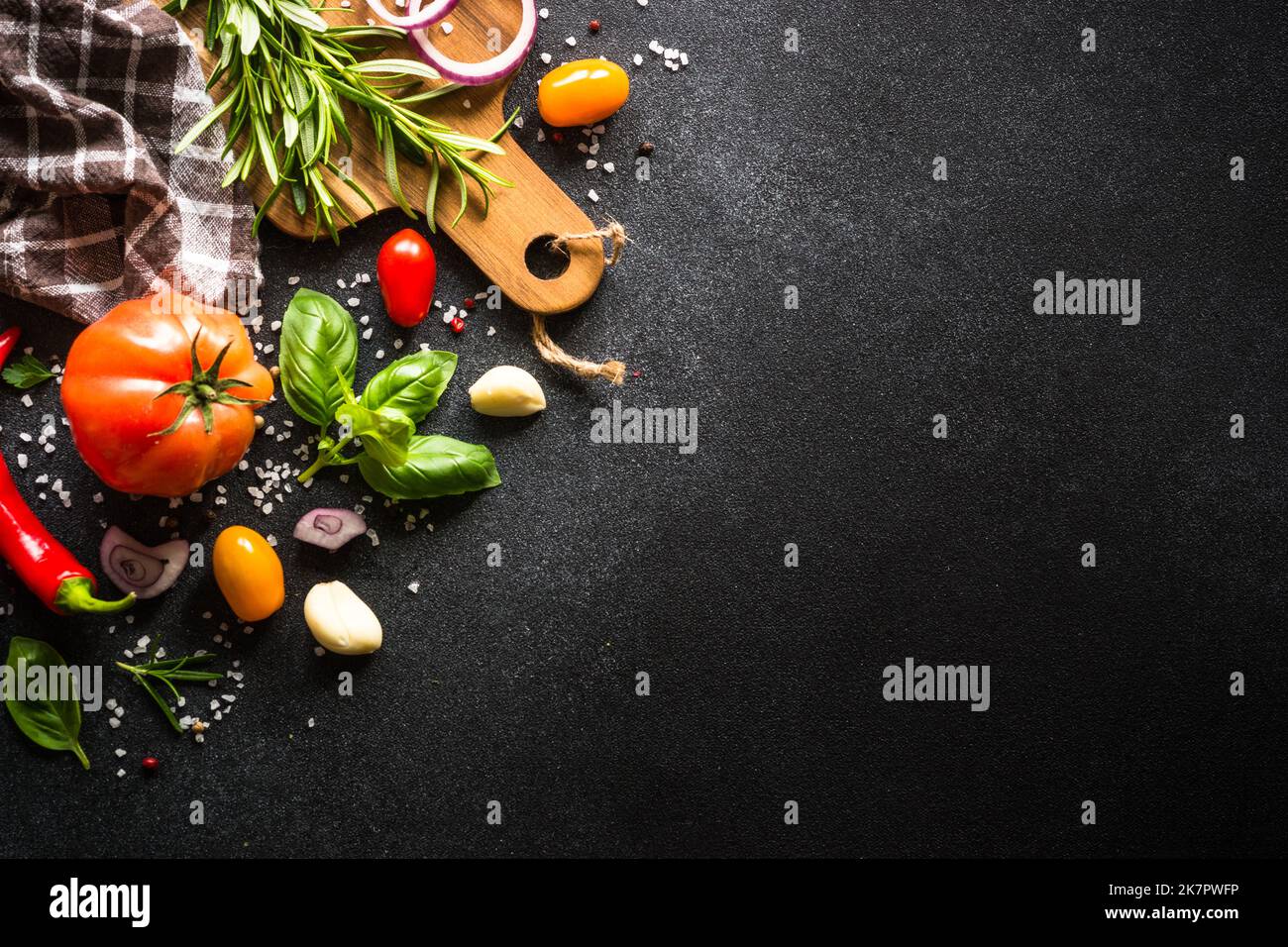 Food cooking background on black stone table Stock Photo - Alamy