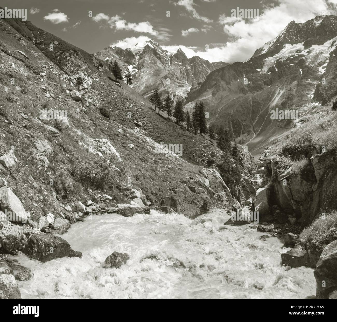 The glacial stream with the Jungfrau, Mittaghorn and Grosshorn peaks in ...