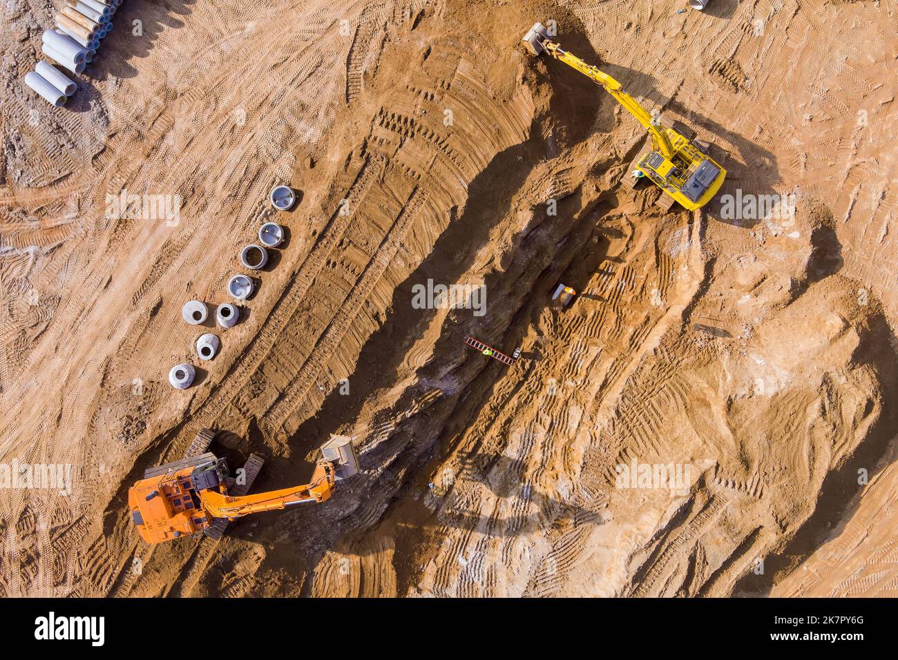 Excavators dig trench on construction site to lay pipe for underground ...