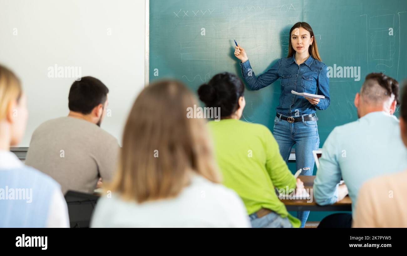 Young woman teacher is giving a lecture to students Stock Photo - Alamy