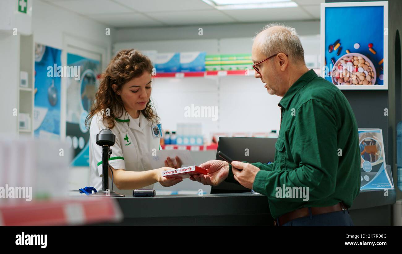 Medical worker helping senior man with prescription medicine, giving ...