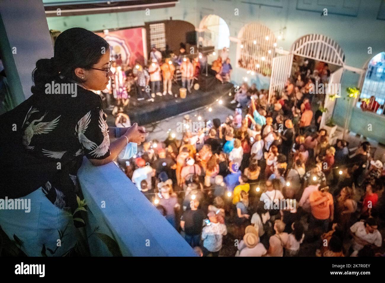 Audience member watching from balcony of Bomba and Plena performance at ...