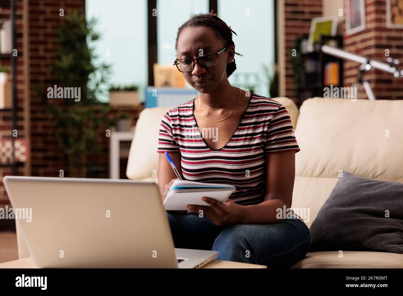 Serious remote student watching educational tutorial, attending online ...