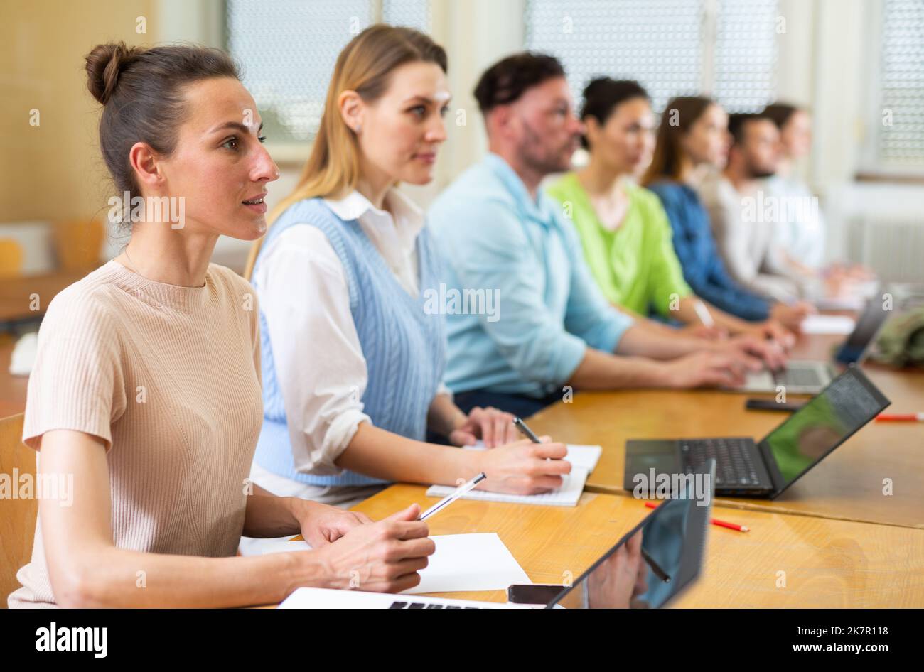 Side view of group of adult students in university classroom Stock ...