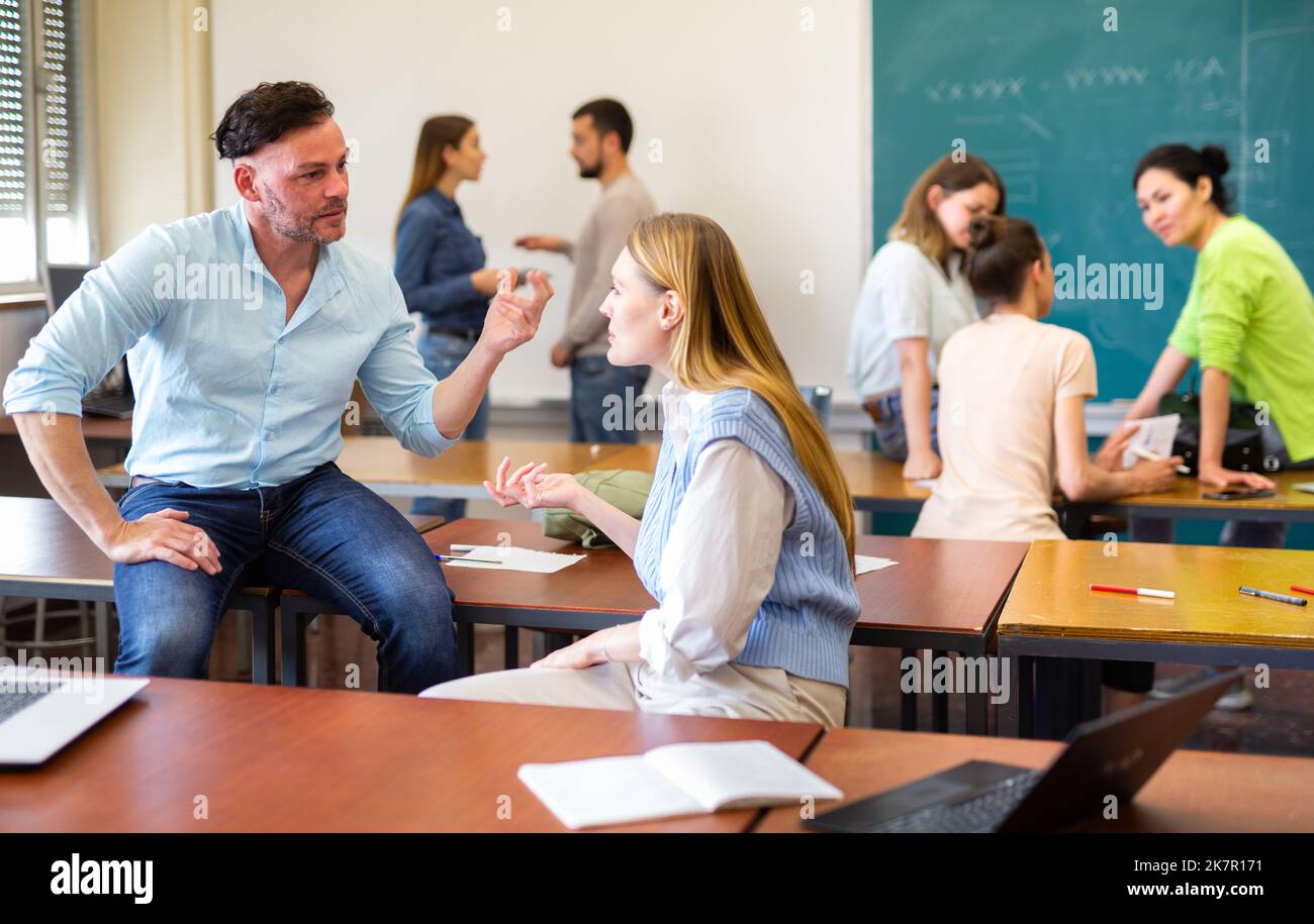 Man and woman students having conversation during recess Stock Photo ...