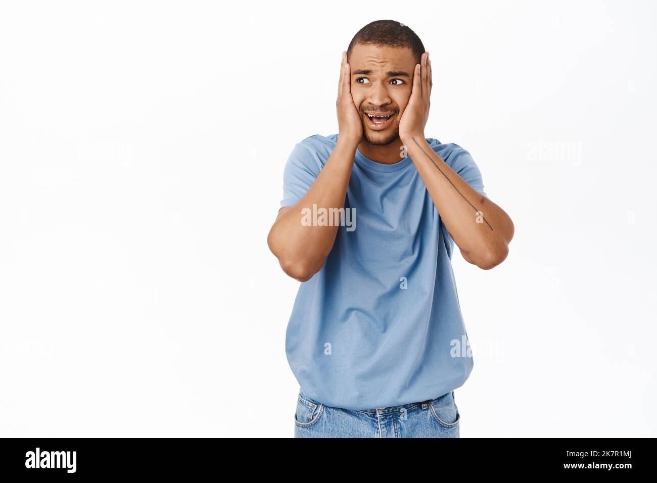 Portrait of scared and worried arab man, holds hands on head and ...