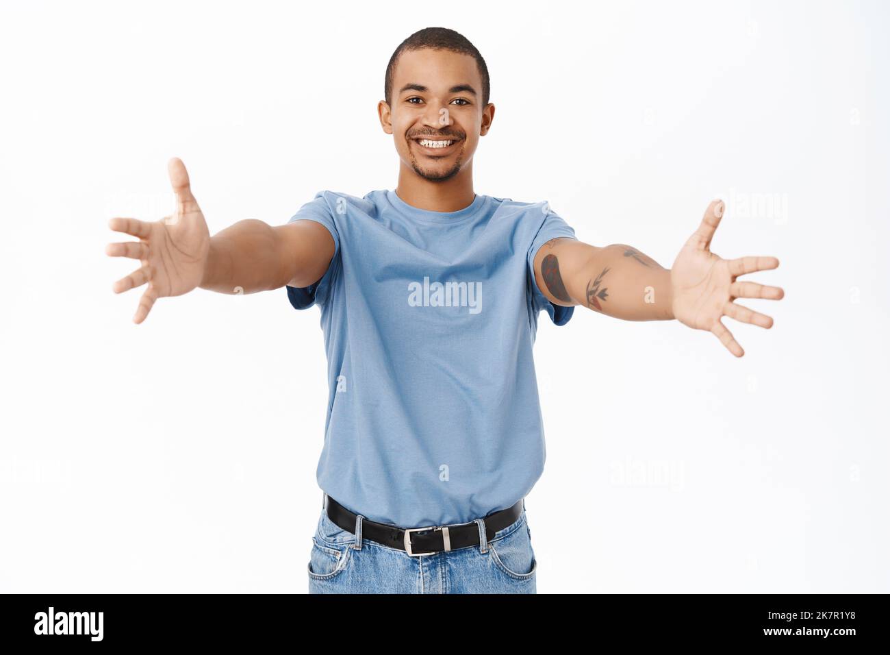 Portrait of happy guy stretching out arms to reach for smth, hugging ...