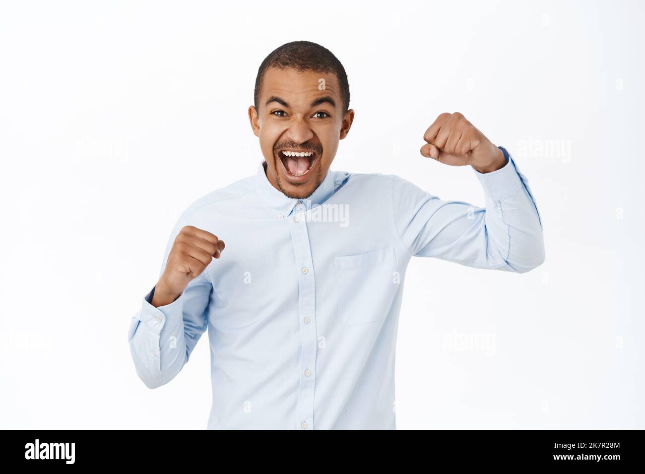 Celebrating success. Excited young man scream of joy, winning and ...