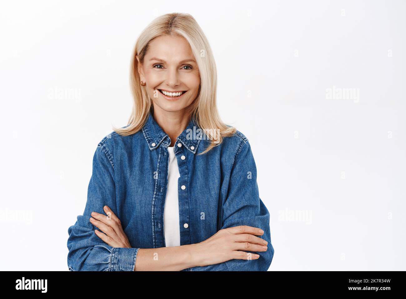 Healthy smiling senior woman, grandmother in stylish outfit, cross arms ...