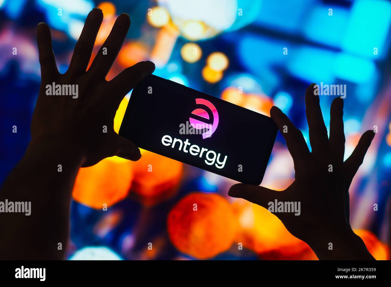 In this photo illustration, the Entergy logo is displayed on a ...