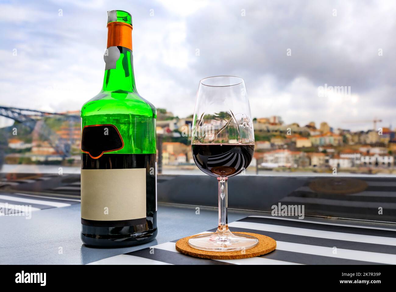 Glass and bottle of red ruby port wine at an outdoor restaurant in ...