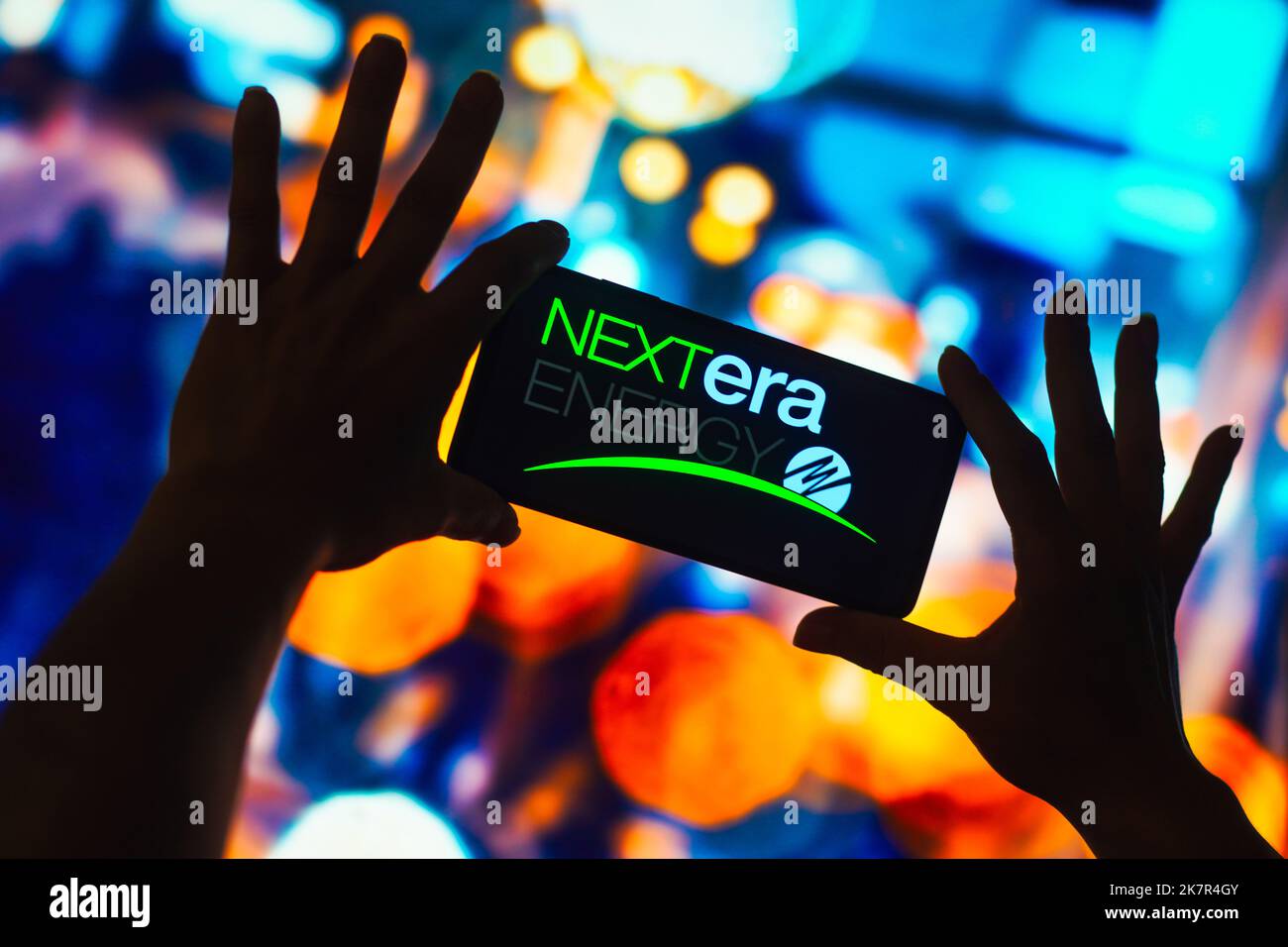In this photo illustration, the NextEra Energy logo is displayed on a ...