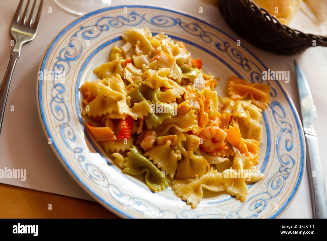 Spanish cuisine seafood pasta with fish and prawns served at plate ...