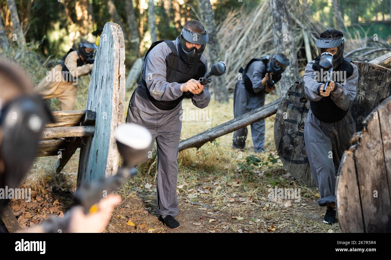 Teams facing on battlefield in outdoor paintball arena during match ...