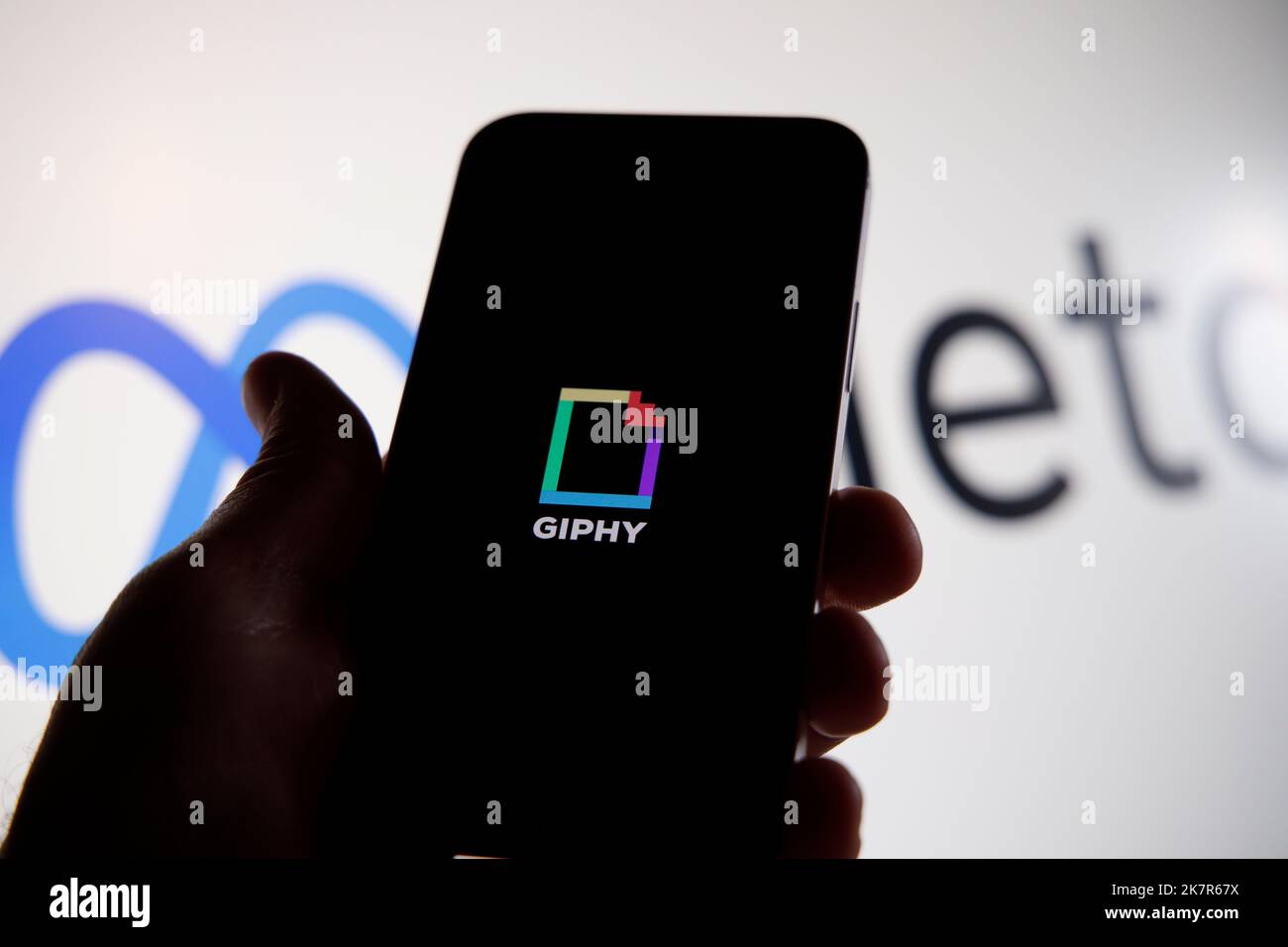 The Giphy logo is seen on a mobile device with the Meta logo in the ...