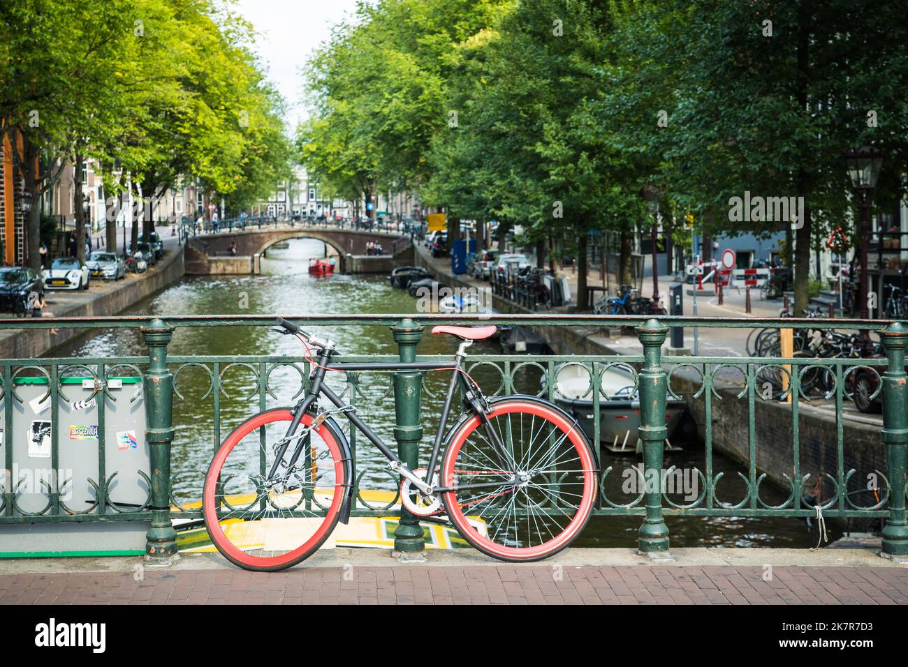 Canal view with bicycle and bridges in Amsterdam Stock Photo - Alamy