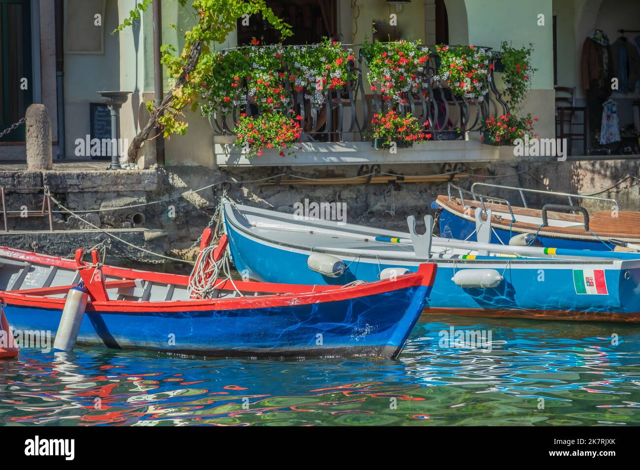 Idyllic Limone sul Garda pier with colorful boats at summer, Italian ...