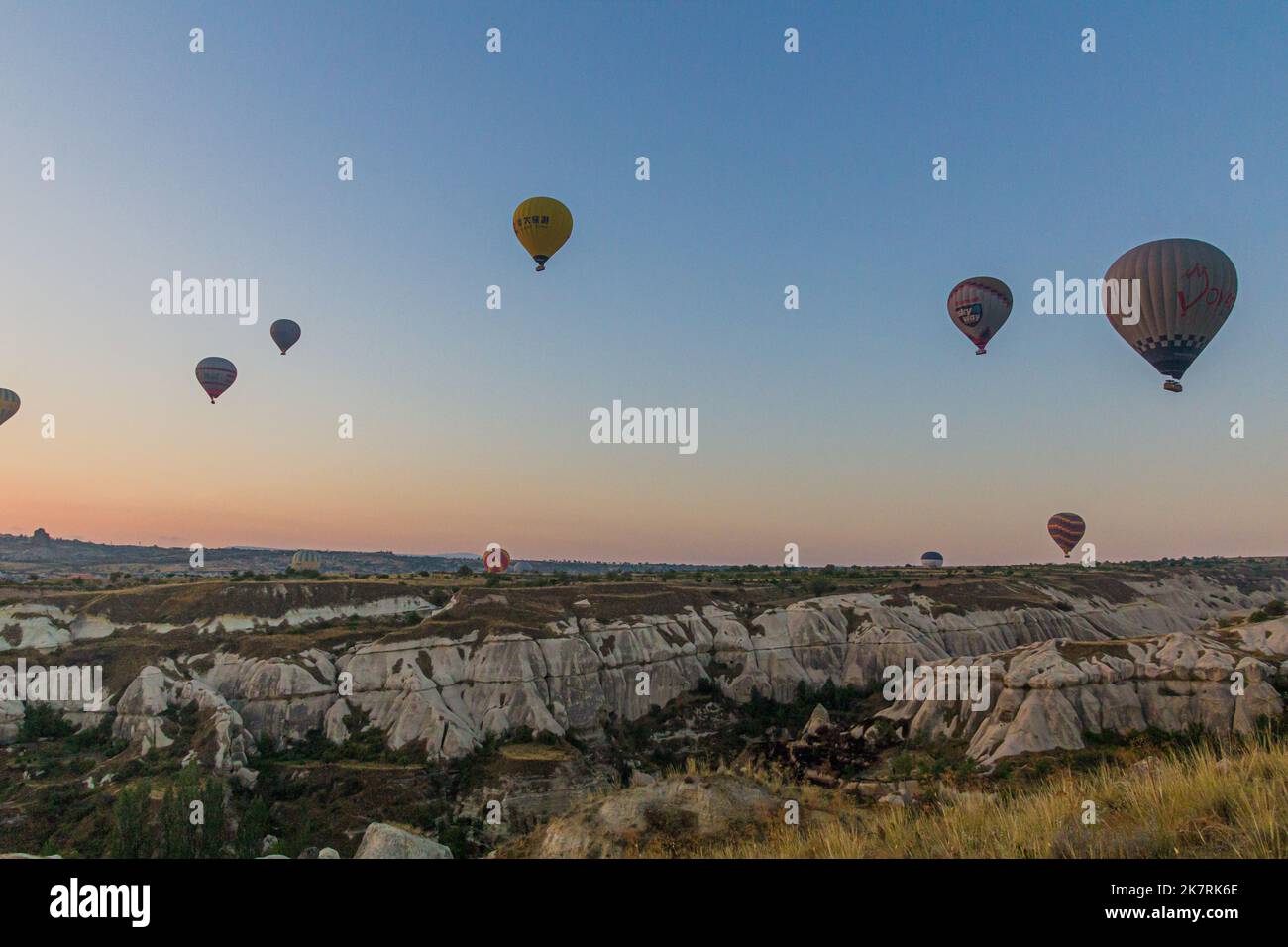 GOREME, TURKEY - JULY 20, 2019: Hot air balloons above Cappadocia ...