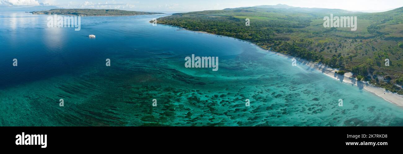 An expanse of sand and seagrass fringes a beautiful beach on the island ...