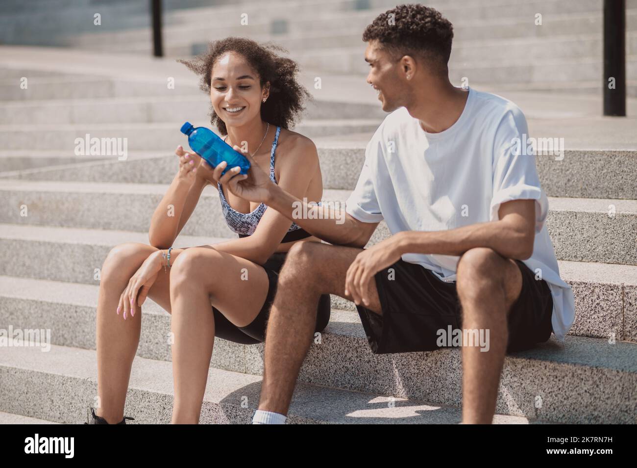 Two young people resting after workout and looking relaxed Stock Photo ...