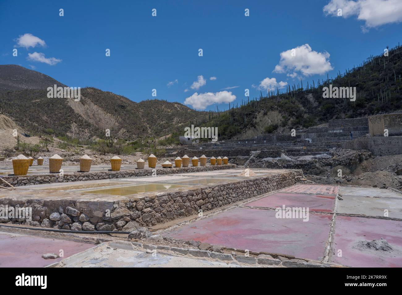 View of the saline pools and baskets of drying salt at a salt mining ...