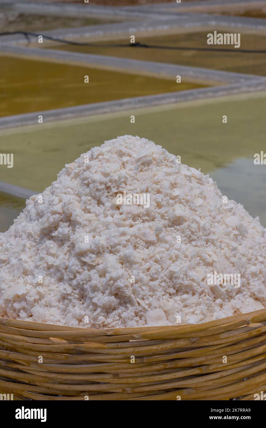 Salt is drying in baskets on the side of the saline pools at a salt ...