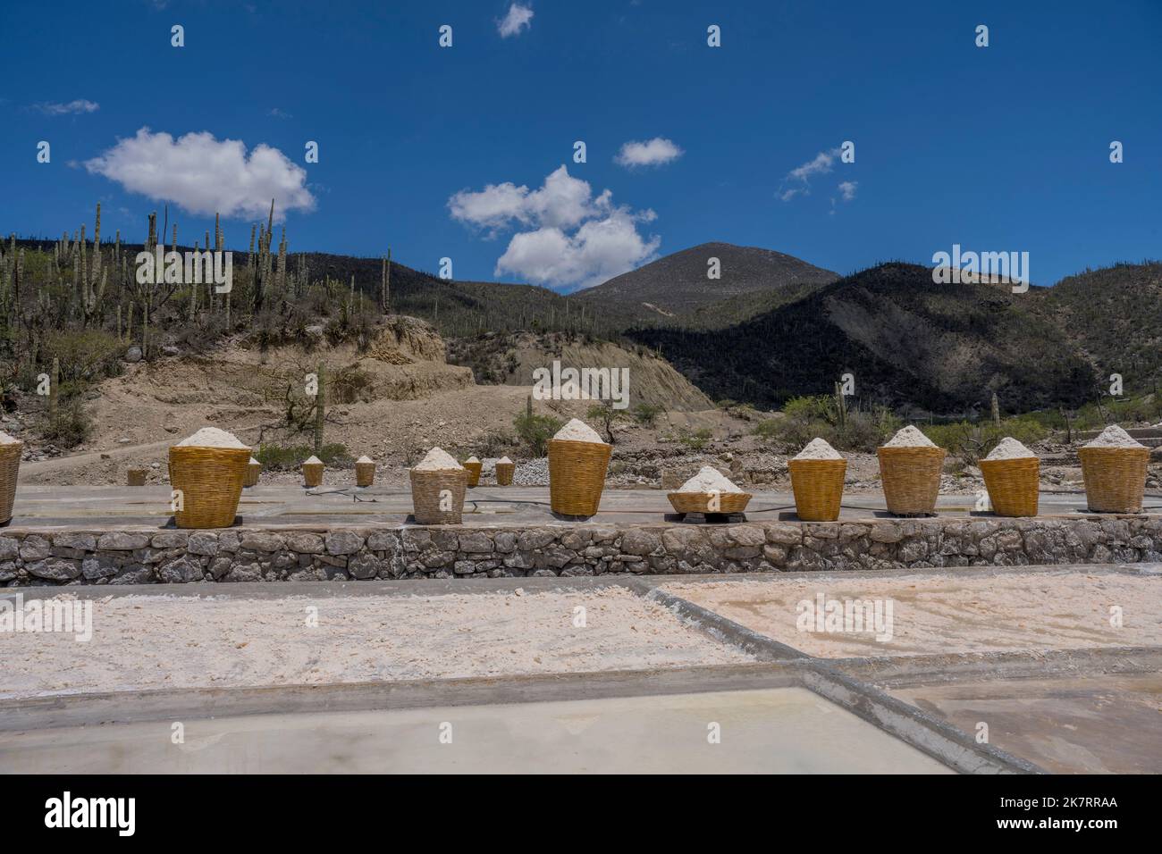 View of the saline pools and baskets of drying salt at a salt mining ...
