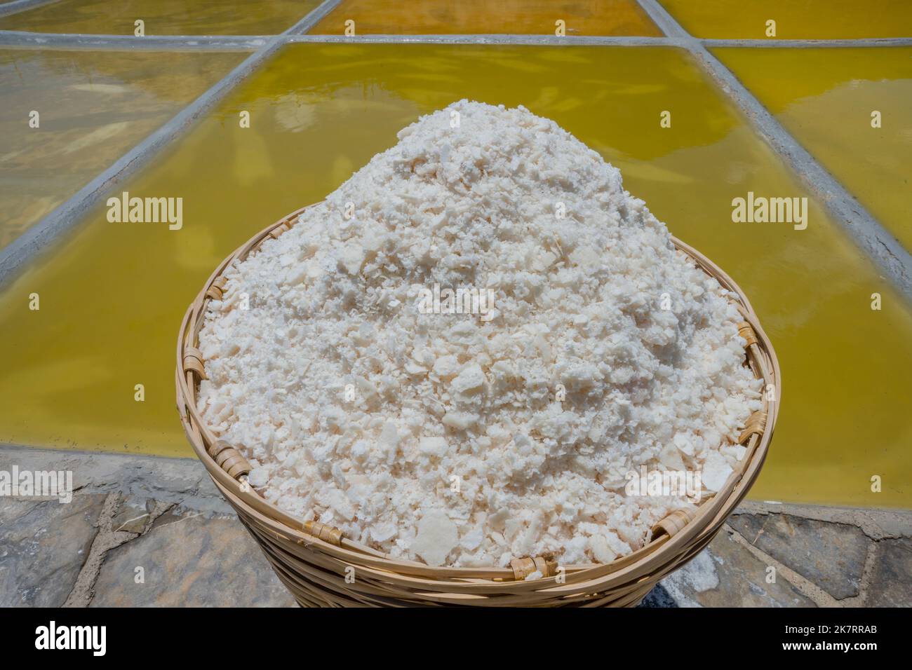 Salt is drying in baskets on the side of the saline pools at a salt ...