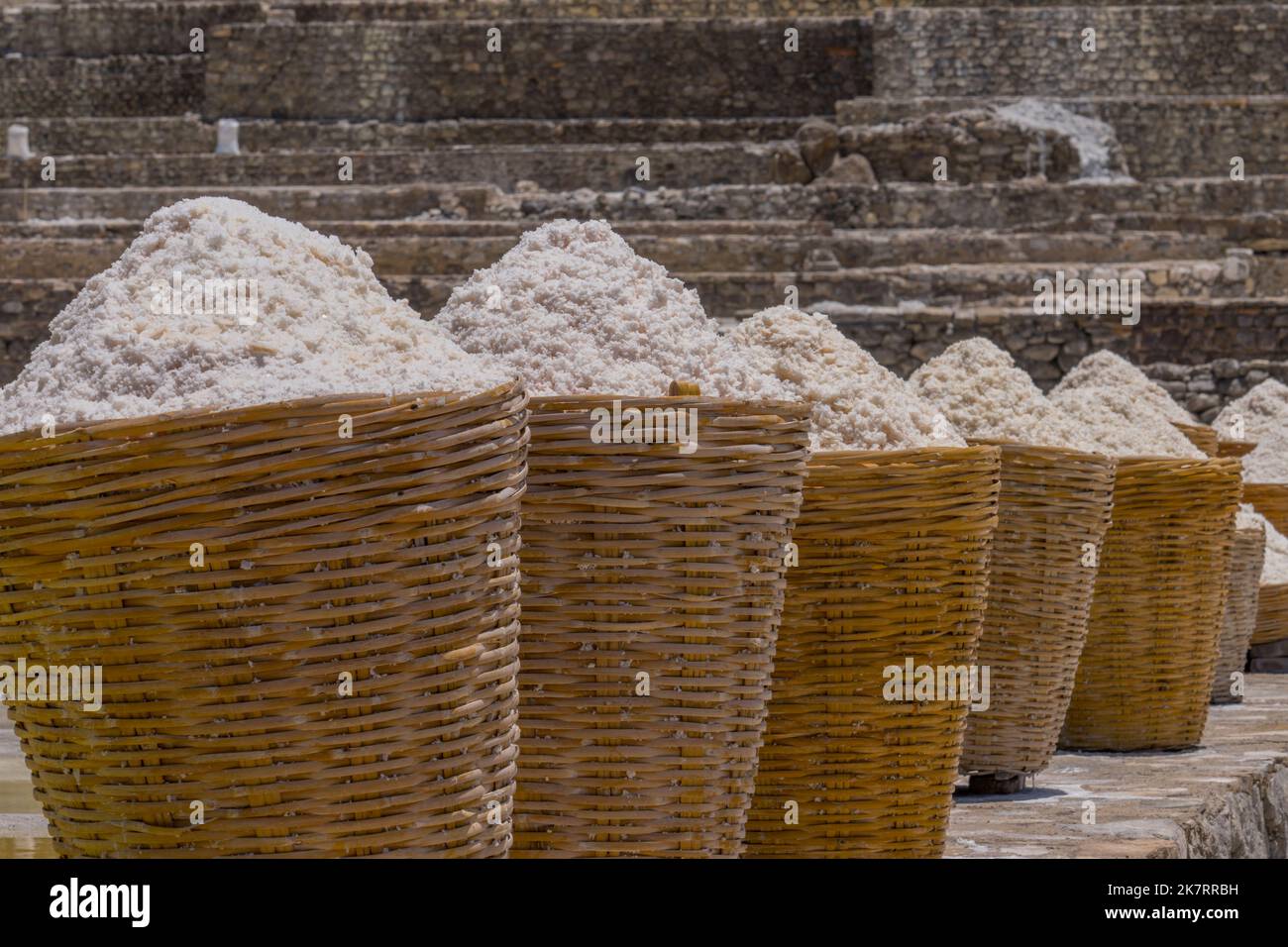 Salt is drying in baskets on the side of the saline pools at a salt ...
