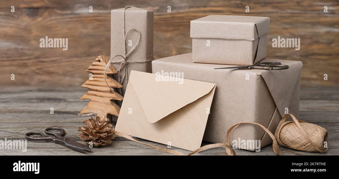 Different gift boxes for Christmas with envelope on wooden background ...