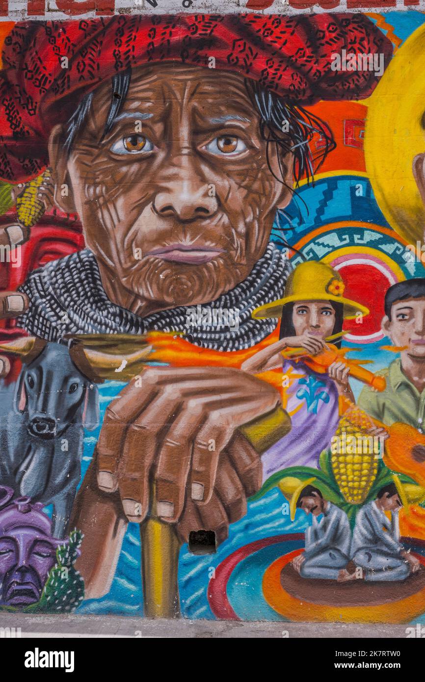 A street scene with a colorful mural in Mitla, a small town in the ...