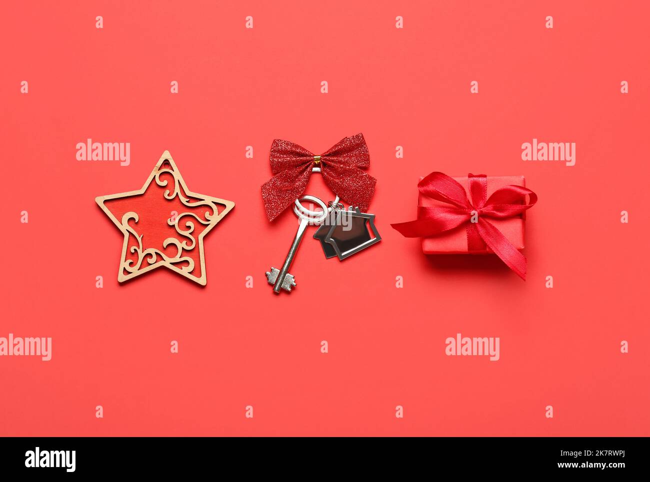 Key from new house, Christmas gift and star on red background Stock ...