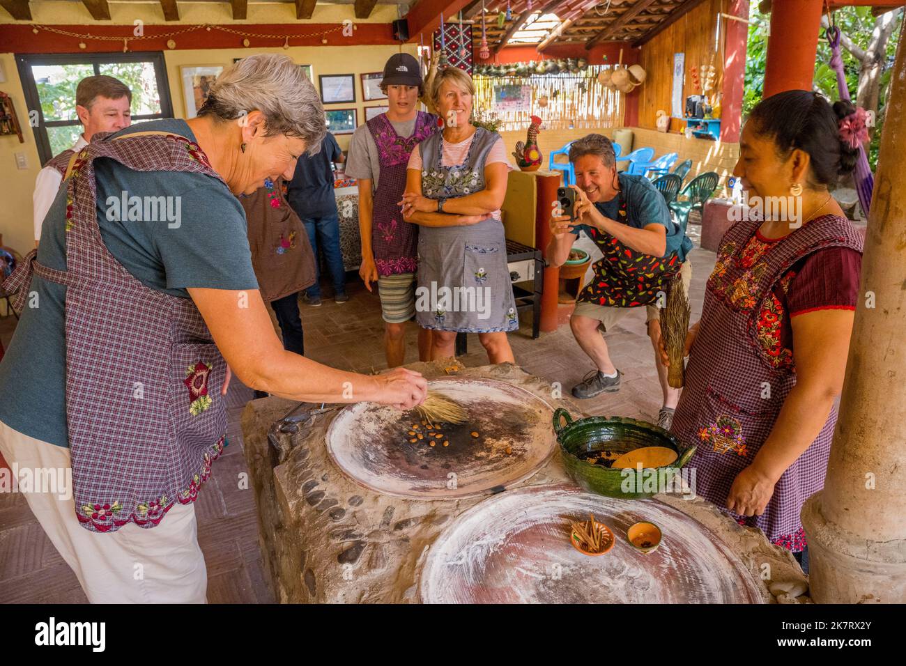 The roasting of ingredients on an traditional oven for making a red ...