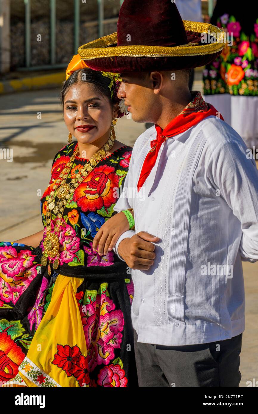 A couple is performing a traditional dance in the Guelaguetza in the arena of San Antonino ...