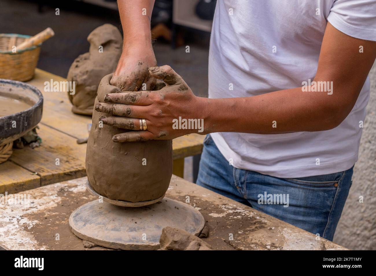 Two discs used as a pottery wheel in a pottery studio making Barro ...