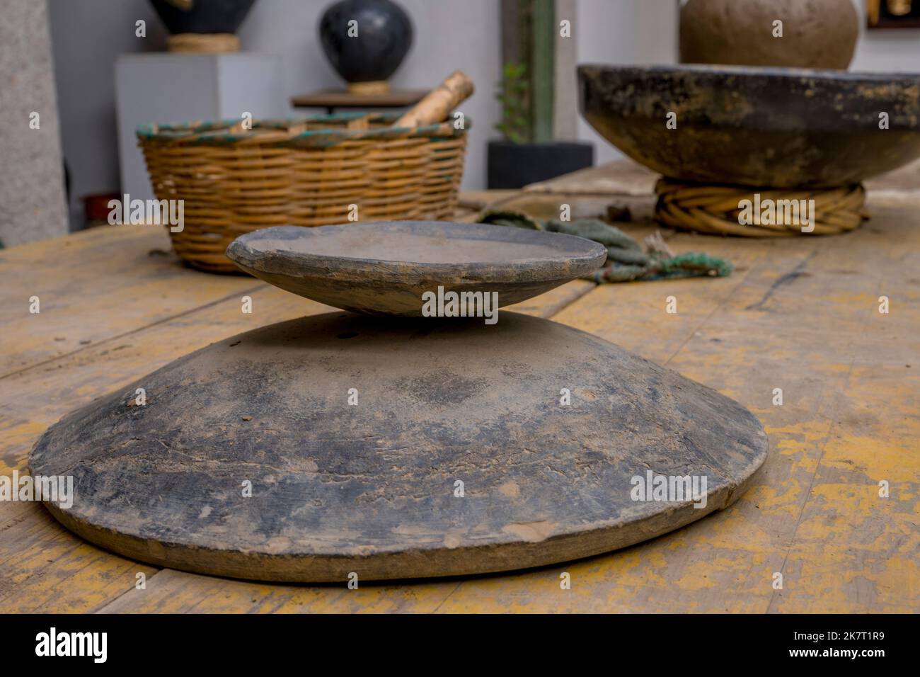 Two discs used as a pottery wheel in a pottery studio making Barro ...