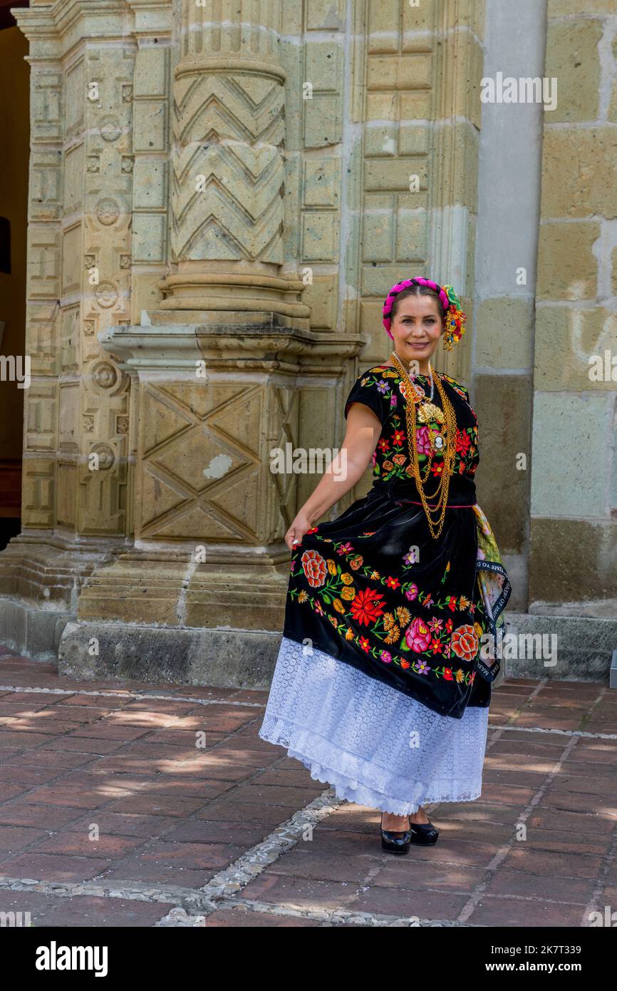 A local woman in traditional dress is posing for photos in a street of ...