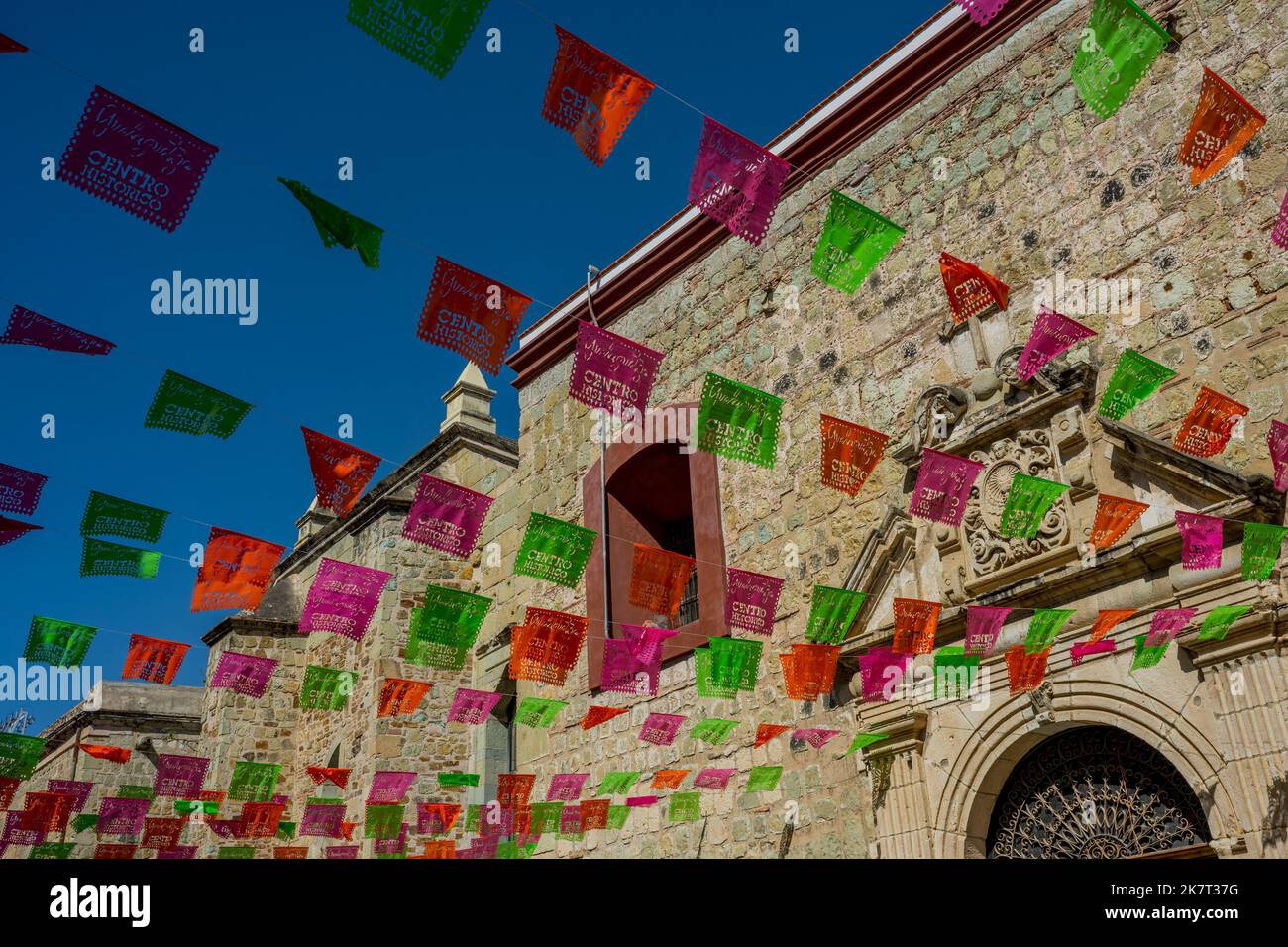 A street scene with Papel picados, a traditional Mexican decorative ...