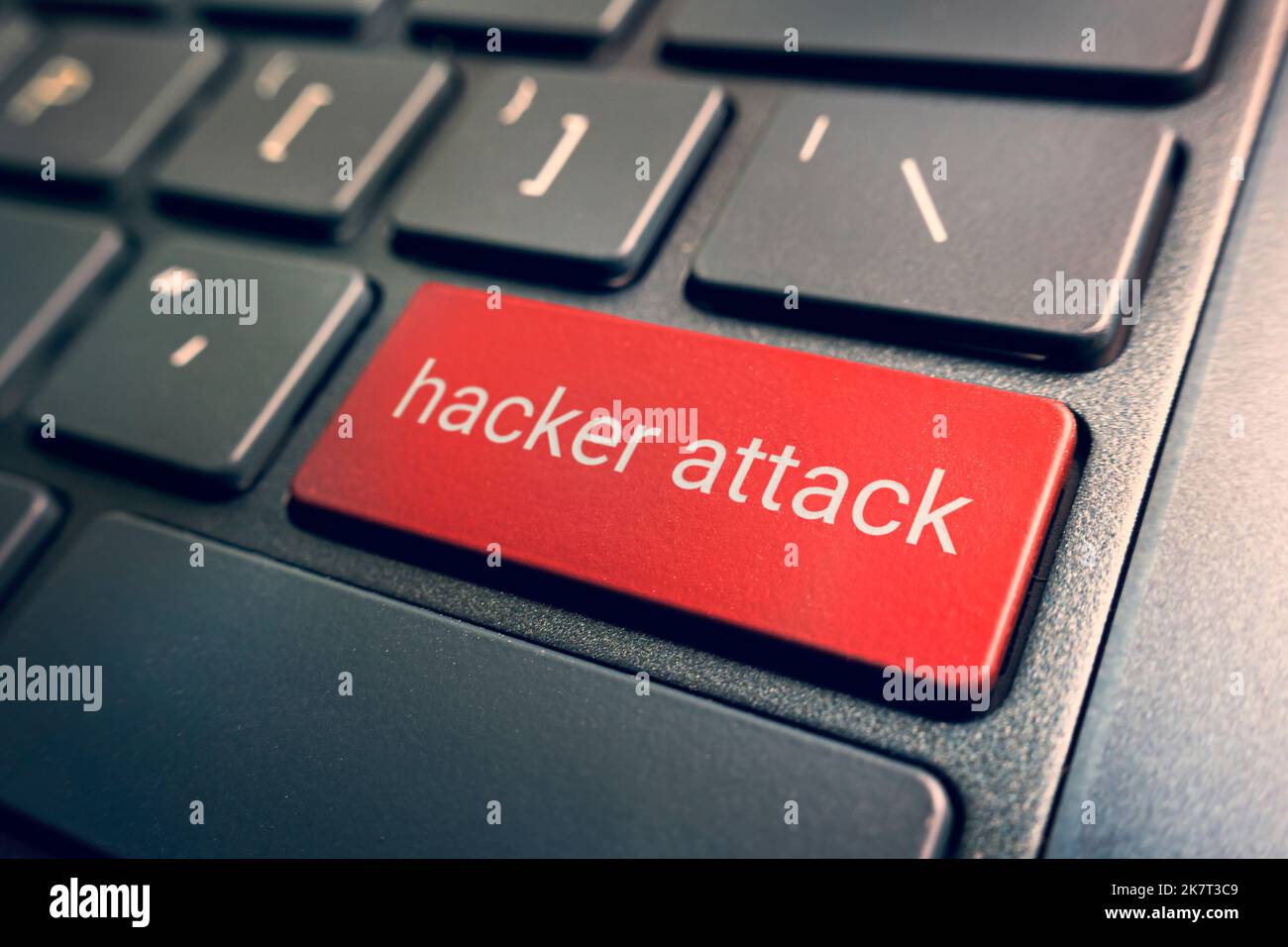 Close-up view on conceptual keyboard - hacker Attack red key on laptop keyboard. blurred ...