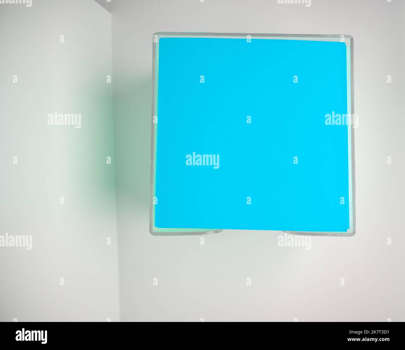 A stack of clean blue sheets of paper on a white background, top view ...