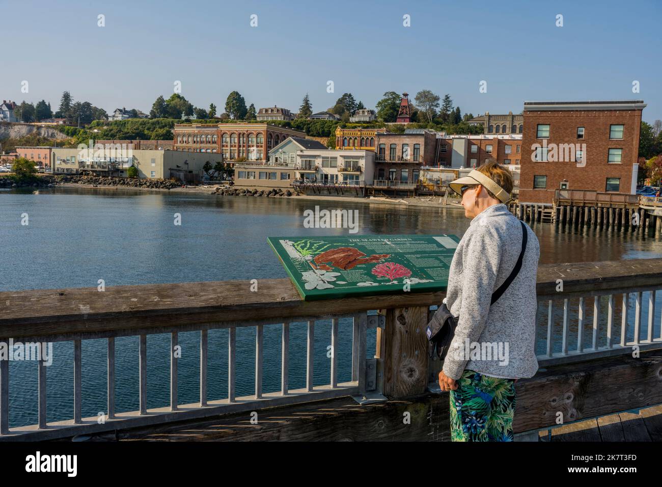 A woman (Model Released) is looking at the information signs on the ...