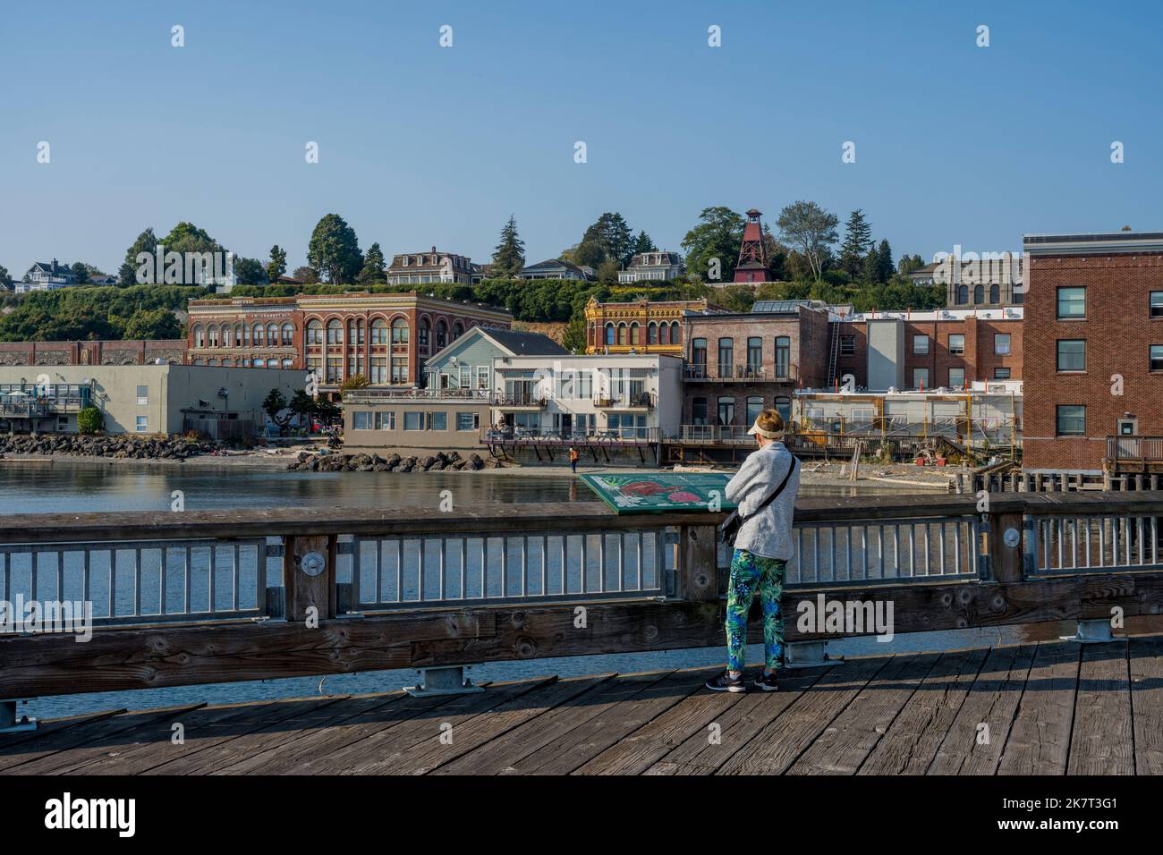 A woman (Model Released) is looking at the information signs on the ...