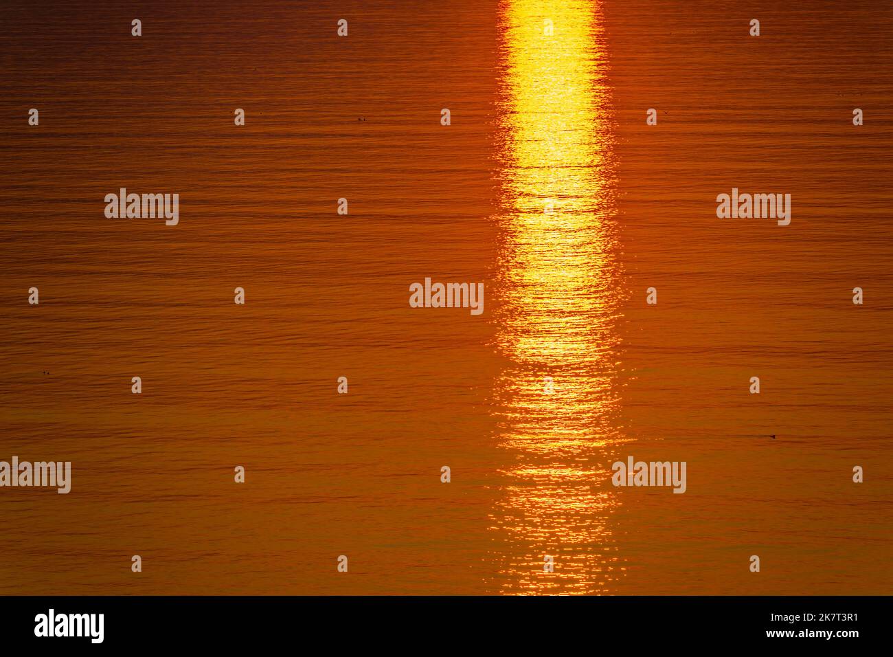 Reflections of the setting sun on the calm waters at the Protection ...